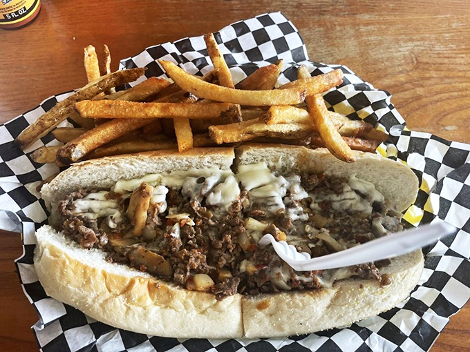 Behold the main event &ndash; thinly sliced ribeye, perfectly melted cheese, and a roll that somehow manages to contain all that glory. Napkins required, not optional.