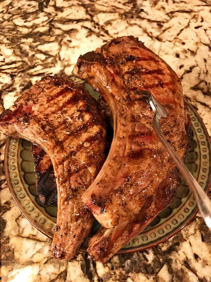Behold the star attraction: pork chops with perfect grill marks that should be in the Smithsonian of Sublime Meat Experiences.