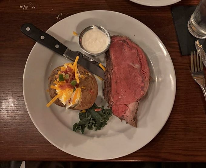 Prime rib so perfectly pink it makes flamingos jealous, served with a loaded baked potato that's having its own little party on the side.