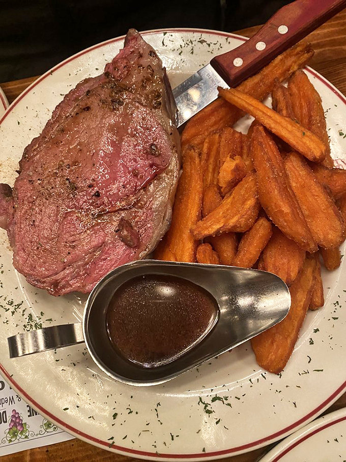 This prime rib isn't just dinner; it's a carnivorous celebration. Perfectly pink, swimming in au jus, with sweet potato fries standing by for the supporting role.