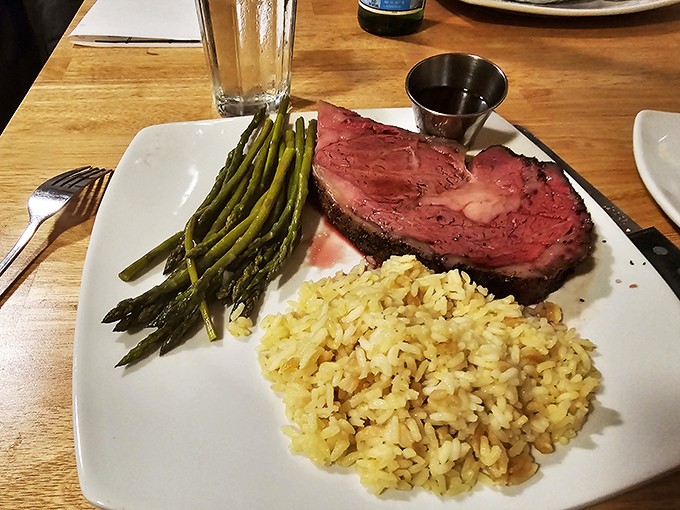 Not just dinner, but a celebration on a plate &ndash; perfectly pink prime rib flanked by asparagus soldiers and rice pilaf ready for duty.