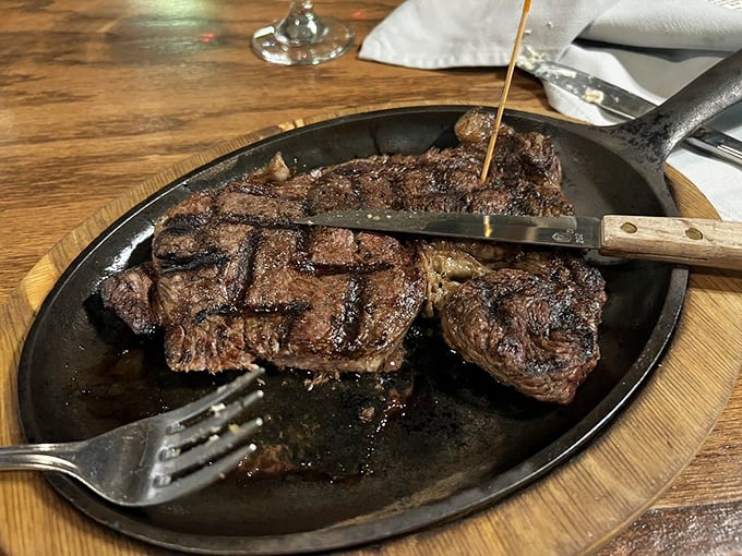 Behold the star of the show! This sizzling ribeye arrives like a carnivore's dream, perfectly seared and ready for its close-up&mdash;and your fork.