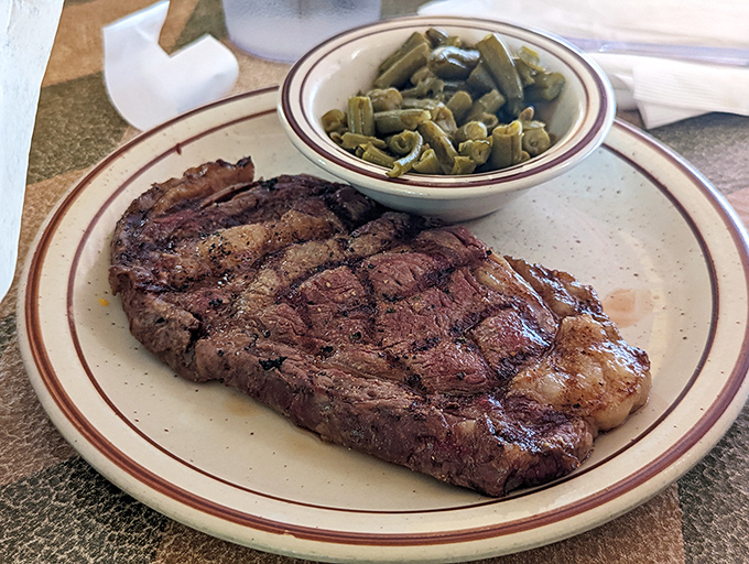 A perfectly grilled ribeye that doesn't need fancy sauces to sing. This steak speaks the universal language of "get in my belly now."