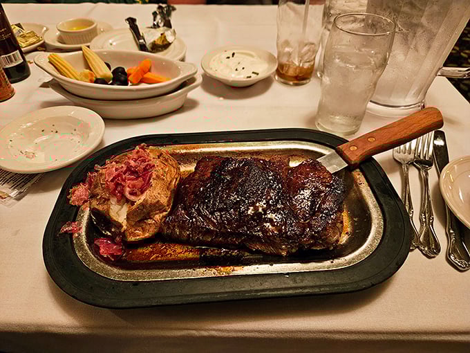 This isn't just a steak; it's a masterpiece with a baked potato sidekick ready to soak up those precious juices.