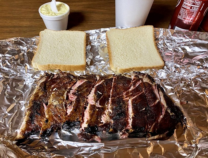 Foil-wrapped ribs presented with white bread &ndash; barbecue's perfect dance partners. No fancy china needed when the star of the show performs this beautifully on humble aluminum.