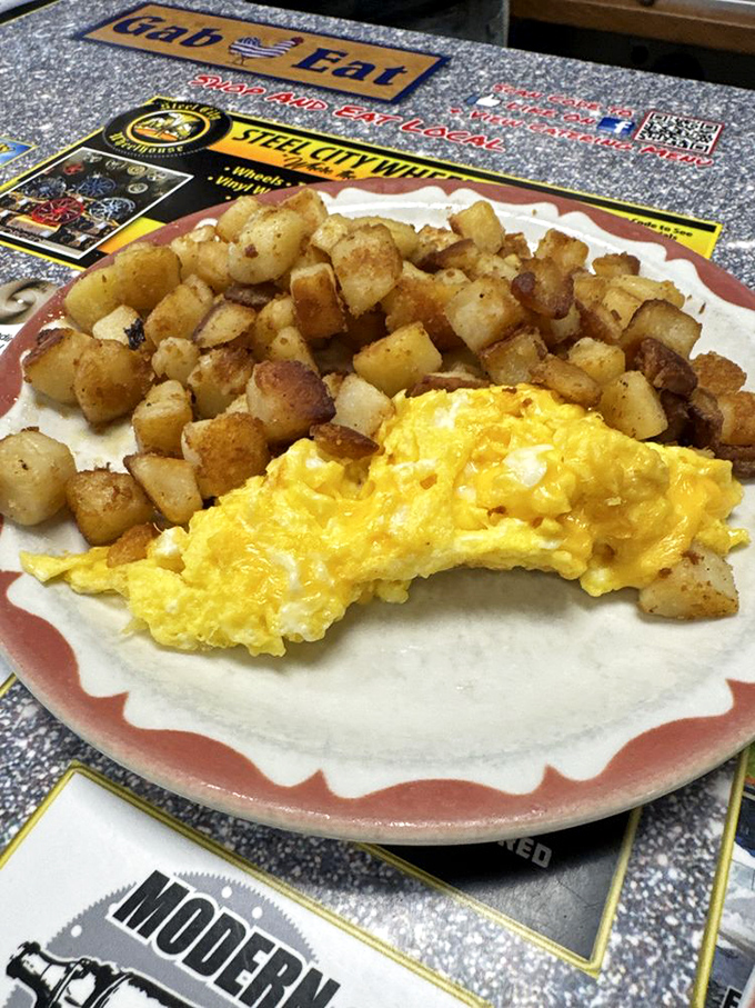 Golden scrambled eggs nestled beside home fries that could make a potato farmer weep with pride. Simple perfection on a plate. 