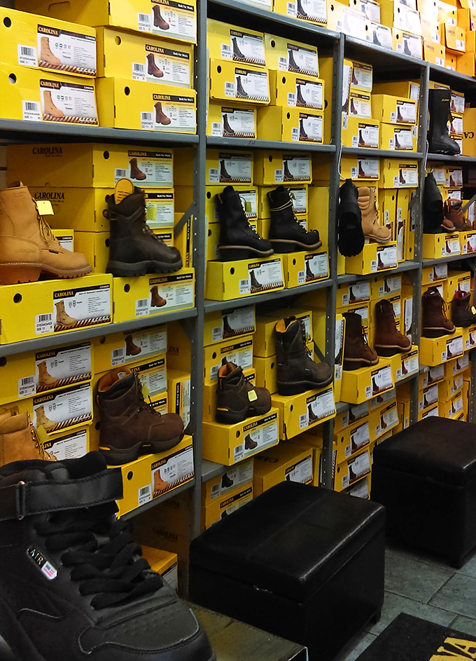 The boot section could outfit a small army&mdash;or just one very indecisive shopper. Yellow boxes stacked like a monument to practical footwear choices.