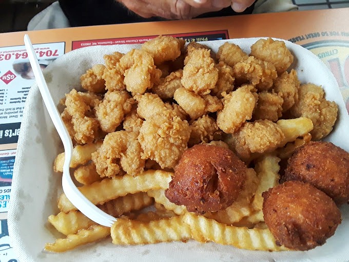 Golden-fried shrimp that snap with freshness, paired with crispy fries and hushpuppies that deserve their own fan club.
