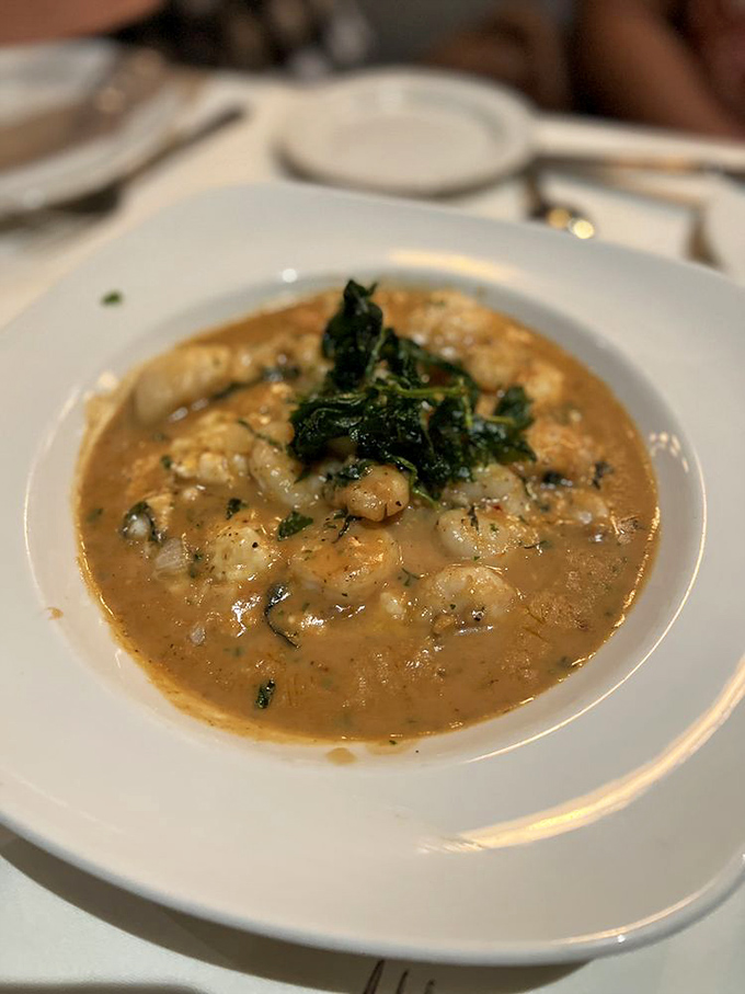 The legendary shrimp and grits arrive looking deceptively humble, but one spoonful will have you planning your next visit before you've finished the first bowl.