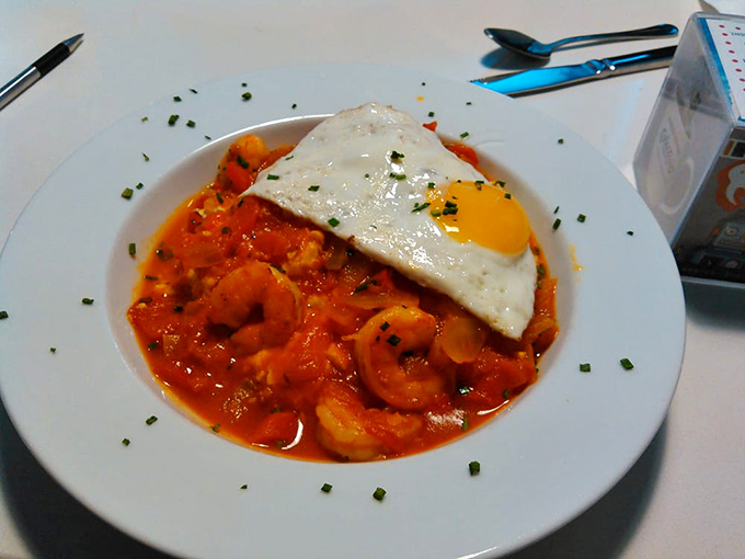 Behold, the famous shrimp and grits in all their glory! That sunny-side egg is like a morning sunshine blessing this Southern classic.