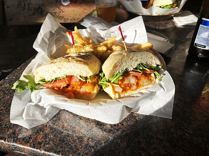This isn't just a sandwich—it's a manifestation of joy between bread. The shrimp po' boy arrives like a rockstar with French fry groupies.