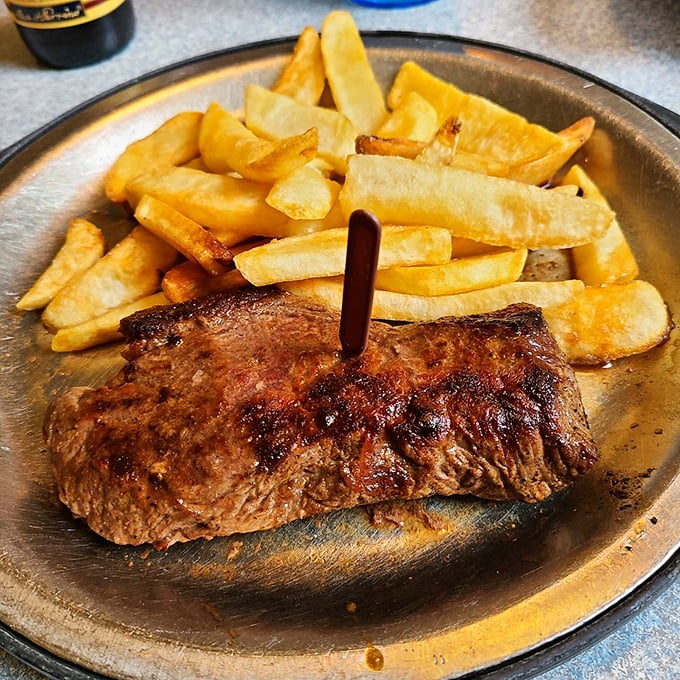 This isn't just a steak; it's a manifesto of simplicity. Perfectly seared sirloin with golden fries&mdash;proof that greatness doesn't require complication.