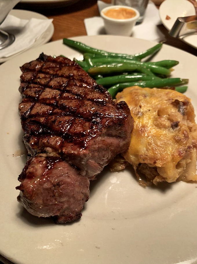 A perfectly grilled steak with the diamond grill marks of champions. That potato looks like it's auditioning for a supporting actor award.