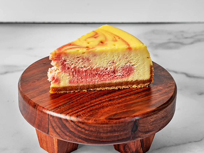 The strawberry swirl cheesecake doesn't just sit on the plate&mdash;it performs. That perfect marble pattern is nature's way of saying "You deserve this."