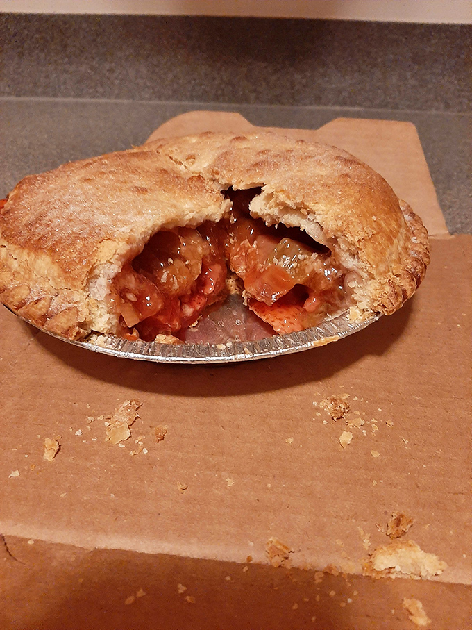 A strawberry rhubarb pie with its golden crust partially devoured&mdash;evidence that willpower is merely a theoretical concept when faced with such perfection.