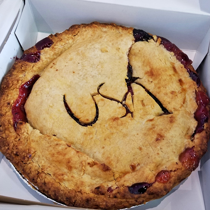 This isn't just pie&mdash;it's edible artwork with "USA" lovingly carved into its golden top. The ruby filling peeks through, teasing what's to come.