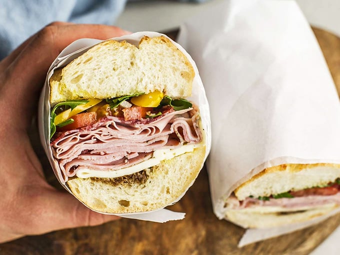 Behold the architectural marvel that is a proper deli sandwich&mdash;layers of ham, cheese, and veggies stacked with the precision of a Frank Lloyd Wright design.