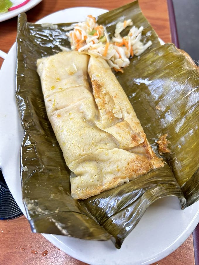 Tamales wrapped in banana leaves like precious gifts from the food gods. The slaw adds that perfect tang, creating harmony that would make Mozart jealous. 