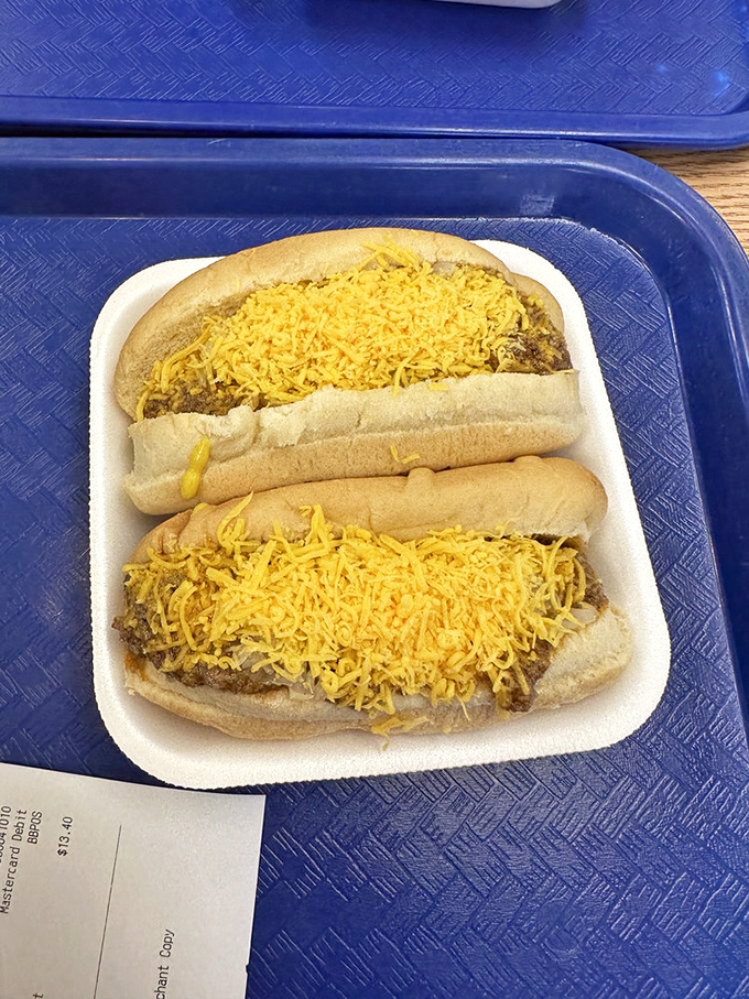 Two cheese coneys on a blue tray&mdash;a pair of golden treasures that prove sometimes the most extraordinary culinary experiences come in the most ordinary packaging.