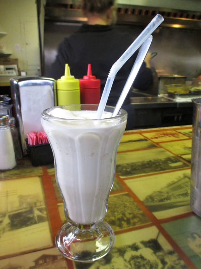 The vanilla milkshake stands at attention, thick enough to require serious straw commitment. This isn't a drink; it's a dessert with ambition.