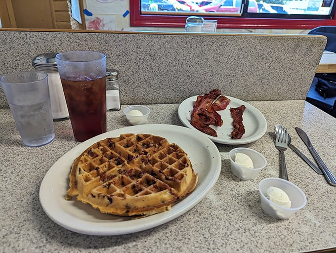 Golden waffle perfection meets crispy bacon in a breakfast duet that's been solving life's problems one maple syrup drizzle at a time.