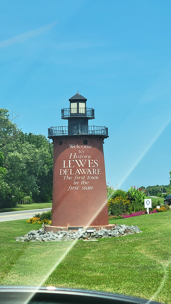 "The first town in the first state" proclaims this lighthouse-inspired welcome sign, greeting visitors with maritime charm and vibrant garden beds.