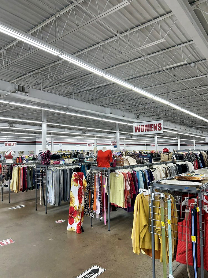 Color-coded clothing racks create a rainbow road of fashion possibilities. Somewhere over these racks, your dream outfit waits.