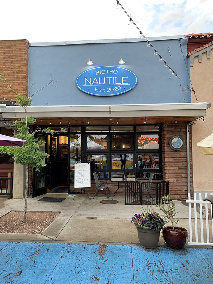Bistro Nautile's charming blue storefront brings a touch of coastal France to Fort Collins' vibrant downtown scene.