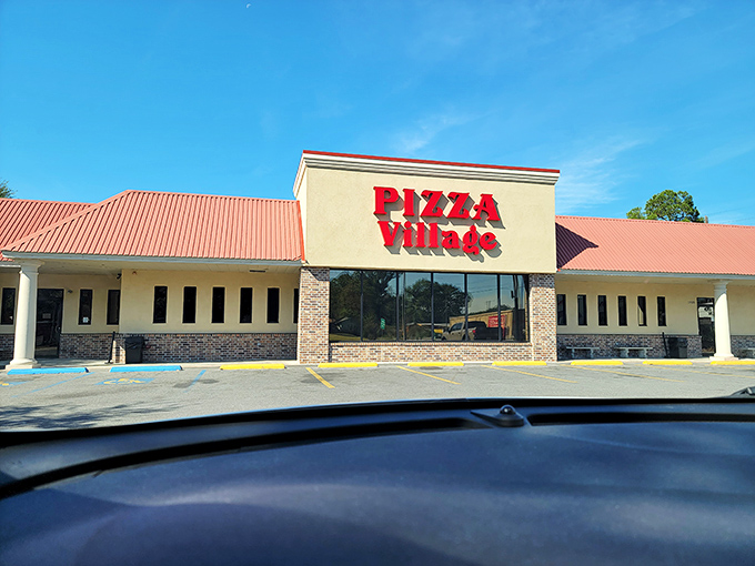 Pizza Village's unassuming storefront hides decades of pizza wisdom within those brick walls.