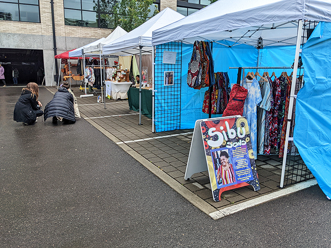 Portland Flea's white tents stand like creative beacons against the gray sky, promising artisanal treasures even on drizzly days.
