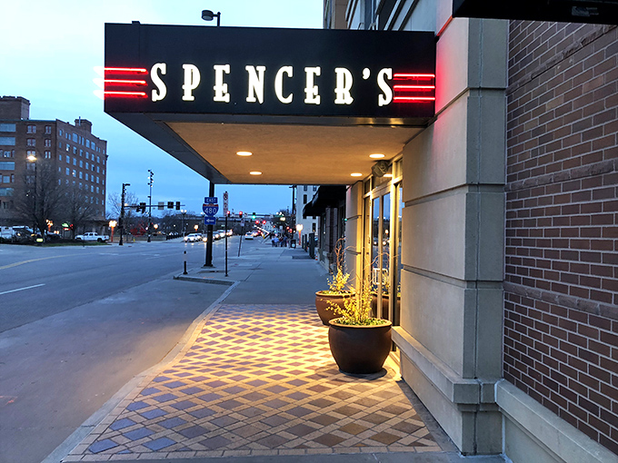 Spencer's sleek, modern entrance lights up the Omaha night. The red glow practically whispers, "Your steak is waiting."