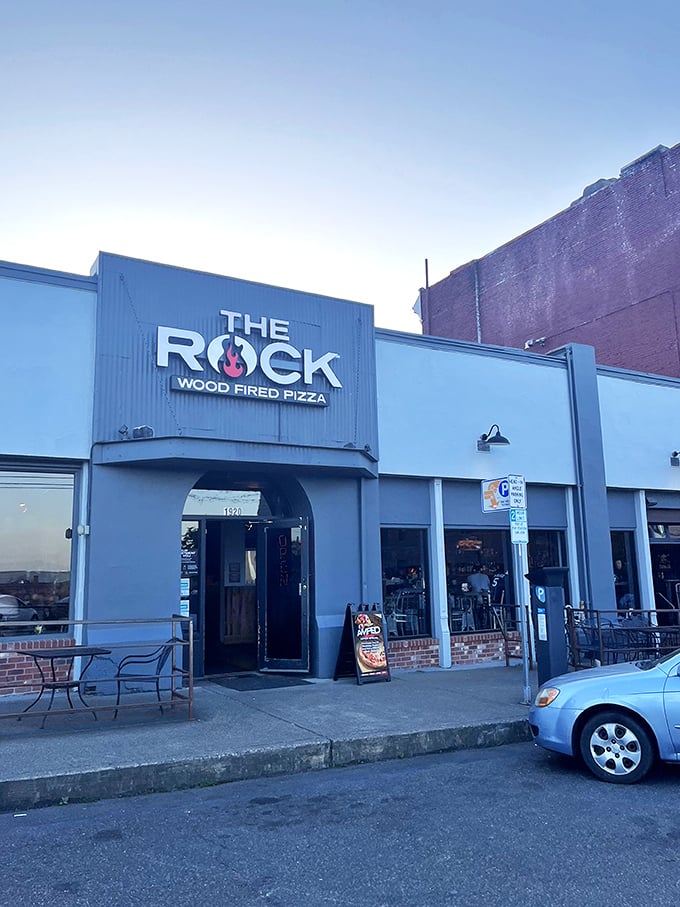 Industrial chic meets pizza perfection. The Rock's blue facade houses flames that transform dough into dreams.