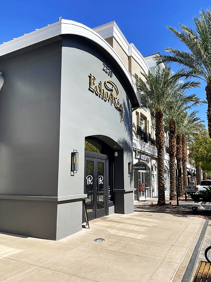 Sunlight streaming through palm trees outside Echo & Rig &ndash; nature's way of highlighting your next great steak adventure.