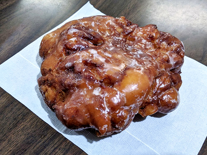 A single apple fritter contains more joy than most wedding cakes, with its perfect balance of crispy exterior and tender, apple-studded interior.