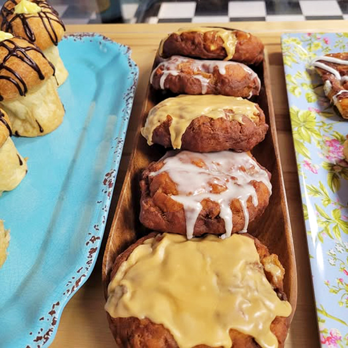Lined up like delicious soldiers ready for duty, these apple fritters showcase the perfect balance of glaze varieties&mdash;each one a masterpiece of contrast.