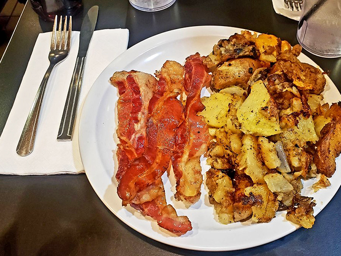 Bacon that doesn't apologize for being bacon, alongside potatoes that clearly graduated from the "more is more" school of breakfast philosophy.