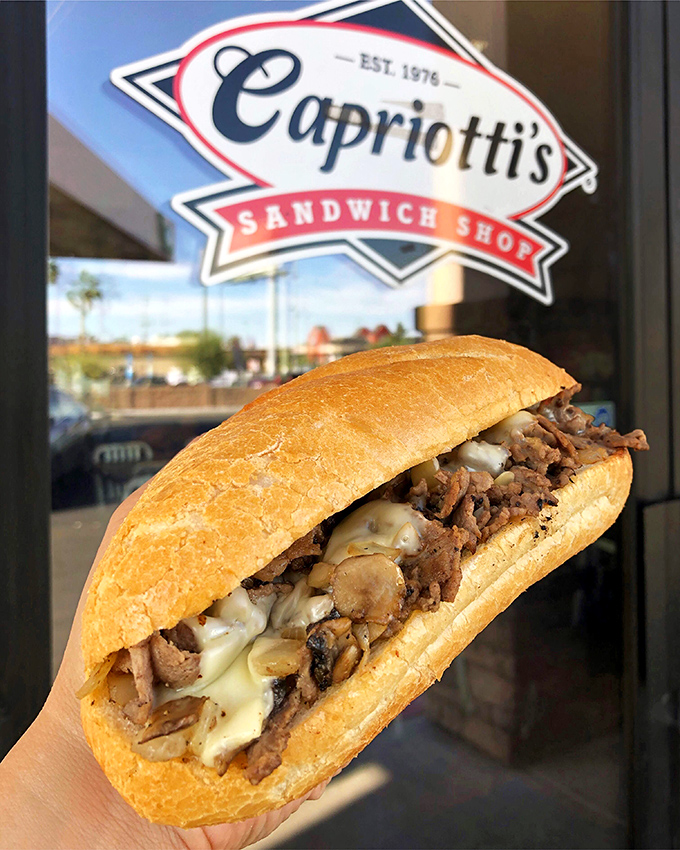 This isn't just a sandwich; it's a masterpiece held together by bread. The melted cheese cascading over tender beef is pure poetry.