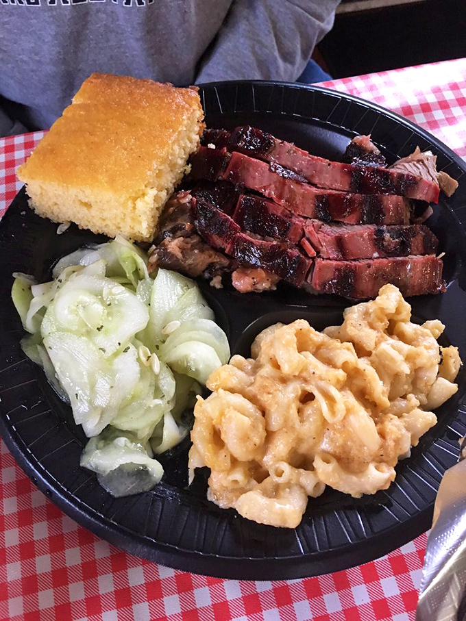 The holy trinity of BBQ perfection: tender brisket, creamy mac and cheese, and tangy cucumber salad. Napkins are non-negotiable here.