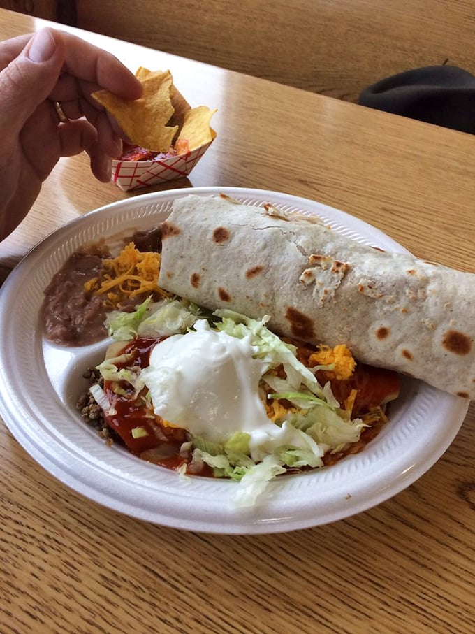 The holy trinity of Mexican comfort: a burrito, refried beans, and that gloriously orange Mexican rice that haunts your dreams.