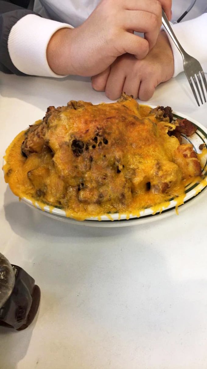 The Loaded Hashbrowns arrive like edible Mardi Gras—cheese, bacon, and toppings celebrating on a plate that barely contains the party.