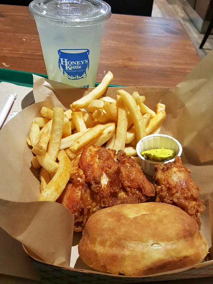 The holy trinity of comfort: crispy chicken, hand-cut fries, and a biscuit that would make your grandmother both jealous and proud.