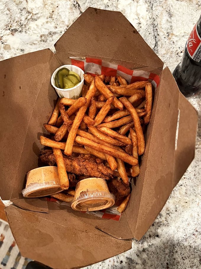 The perfect takeout doesn't exi&mdash; Oh wait, it does. Crispy tenders nestled among golden fries with those essential pickle slices providing crucial acid balance.