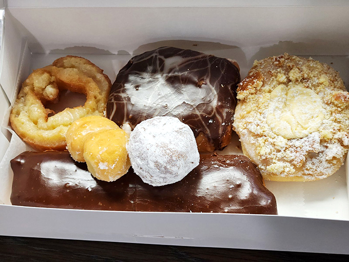 Chocolate-dipped delights nestled beside powdered masterpieces. That chocolate long john is practically begging to meet your coffee.