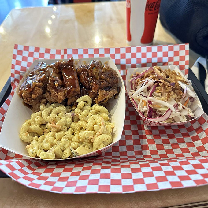 The holy trinity of comfort: glazed chicken, creamy mac salad, and vibrant slaw. A balanced meal if balance means "delicious from every angle."
