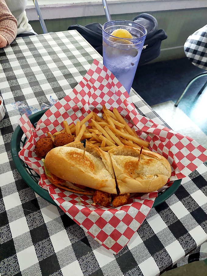 Architecture meets art meets appetite. The grouper sandwich arrives with hushpuppies standing guard like delicious sentinels of Southern hospitality.
