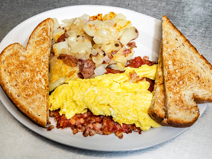 The breakfast trinity: perfectly scrambled eggs, crispy hash, and toast that's actually buttered all the way to the edges. Hallelujah!