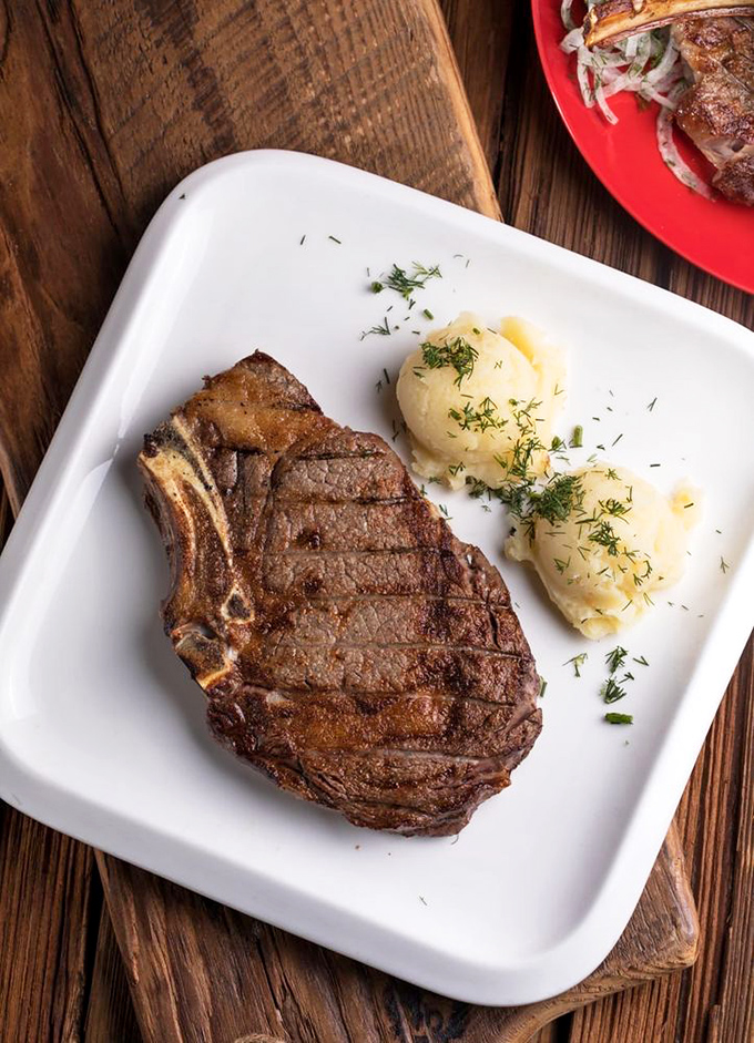 The ribeye and green beans aren't just sharing a plate, they're having a culinary conversation. That crust speaks a language all meat lovers understand.