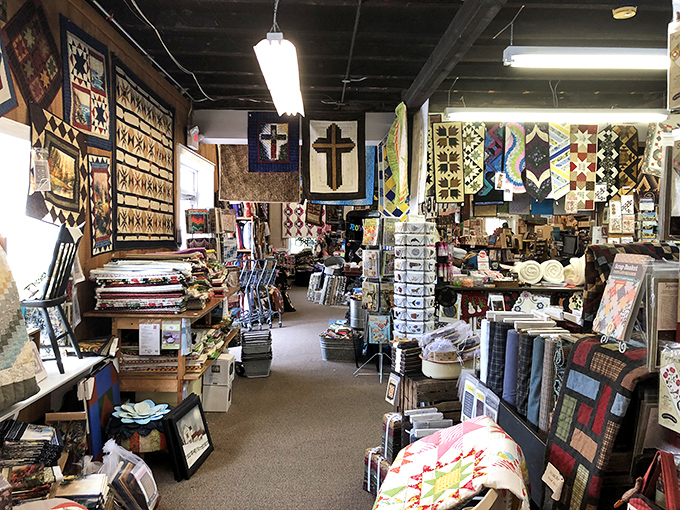 Religious themes and inspirational messages blend seamlessly with the craft. "Amazing Grace" hangs prominently, reminding visitors of the spiritual roots of Amish quilting traditions.