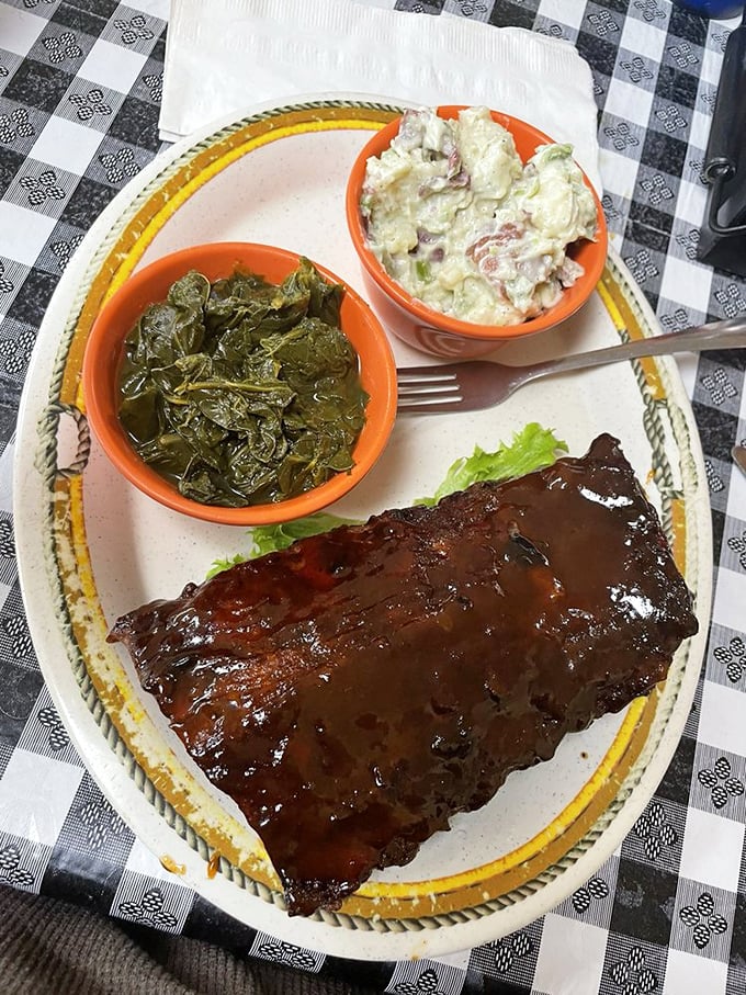 A plate fit for a king! Ribs, greens, and potato salad - it's like the holy trinity of Southern comfort food.