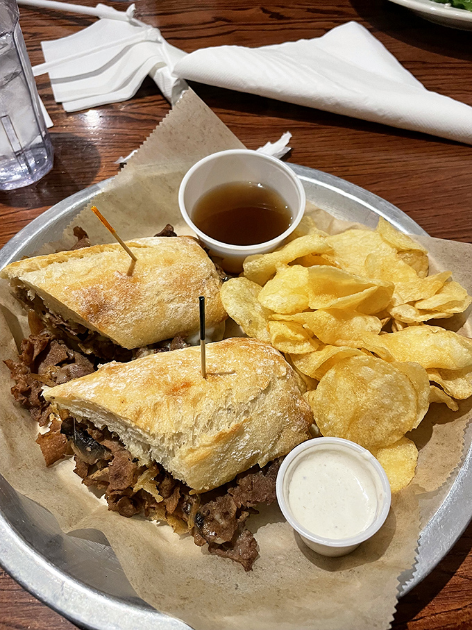 The au jus comes in its own little cup, like liquid gold waiting to transform an already excellent sandwich into something transcendent.